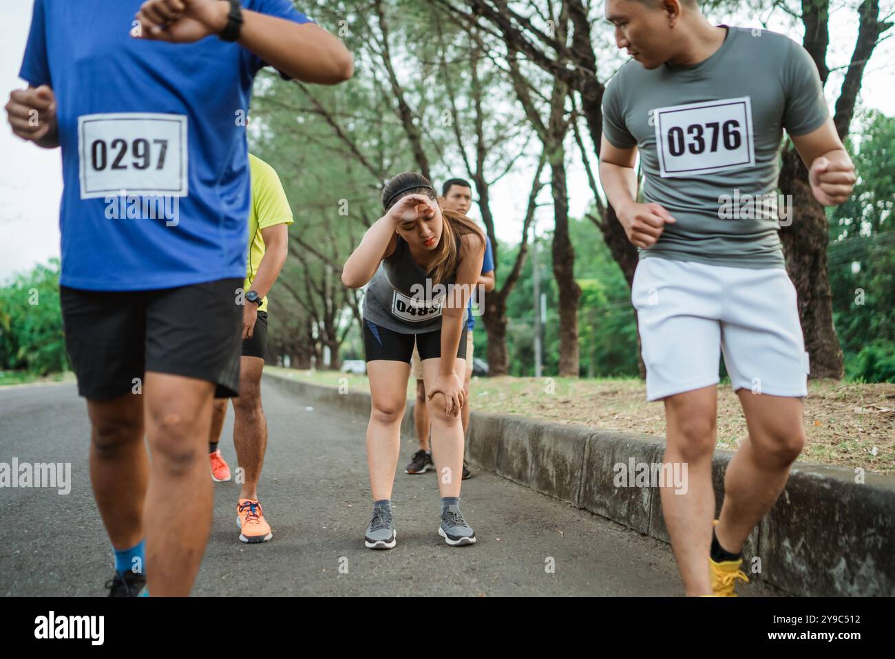 asian female runner feeling exhausted after running Stock Photo - Alamy