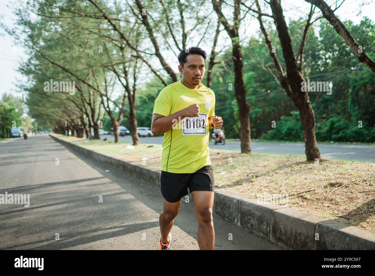 asian male athlete running marathon track Stock Photo - Alamy
