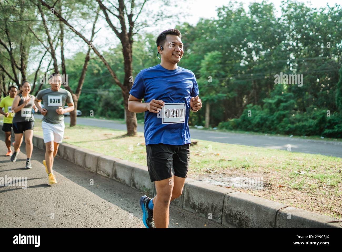 asian male athlete running marathon track Stock Photo - Alamy