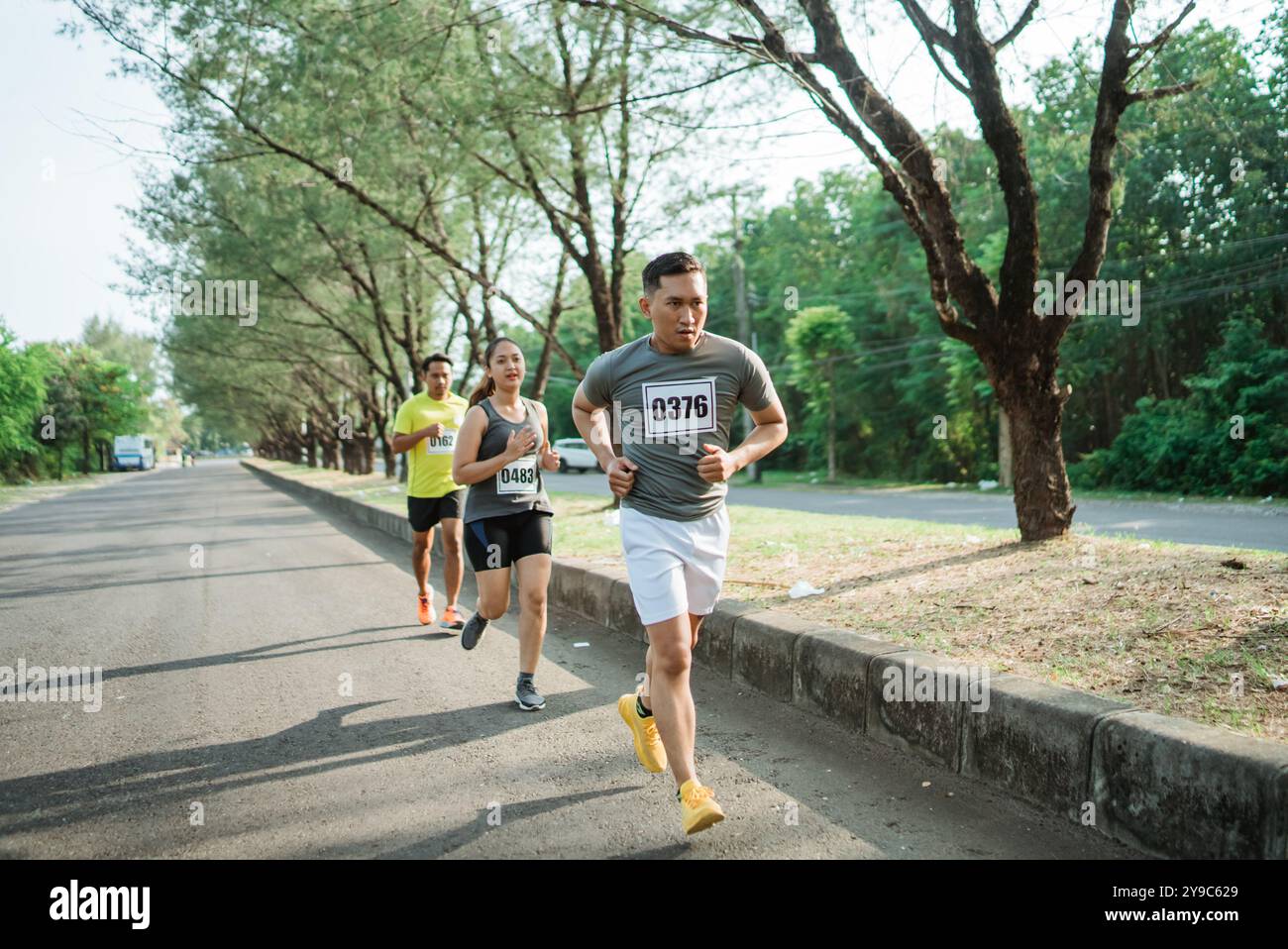 asian athlete running on marathon track passionately Stock Photo - Alamy