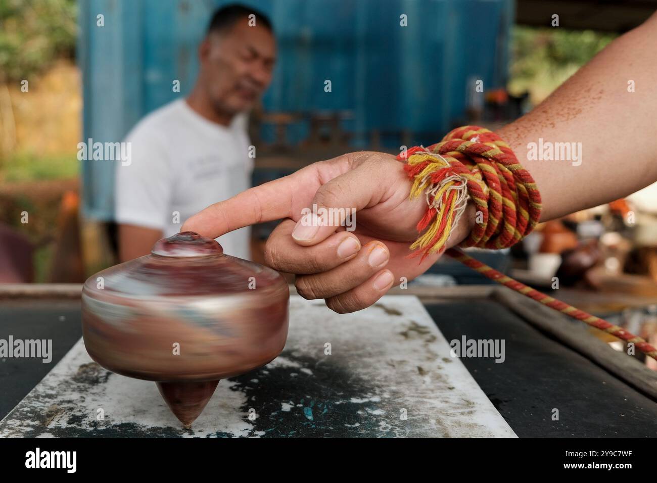 Jimie tests the spinning top at Klang, Selangor. Gasing Pangkah is one ...