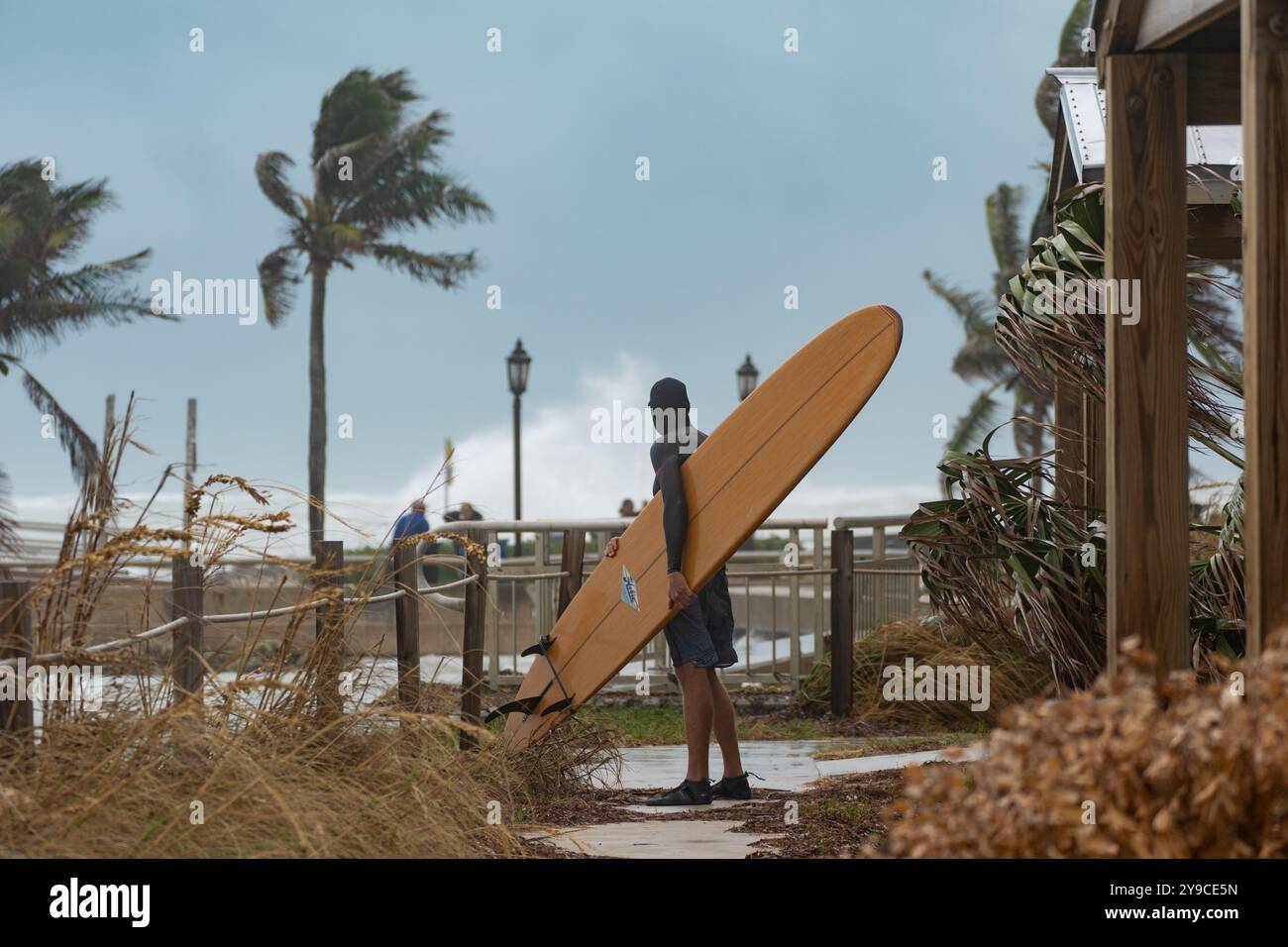 Key West, United States. 09th Oct, 2024. A surfer looks at the water ...