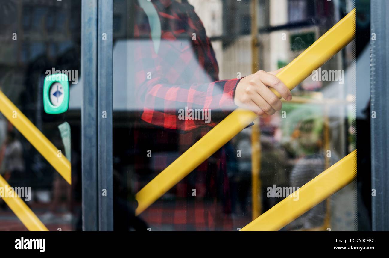 the girl stands near the bus door and holds on to the handrail. traffic ...