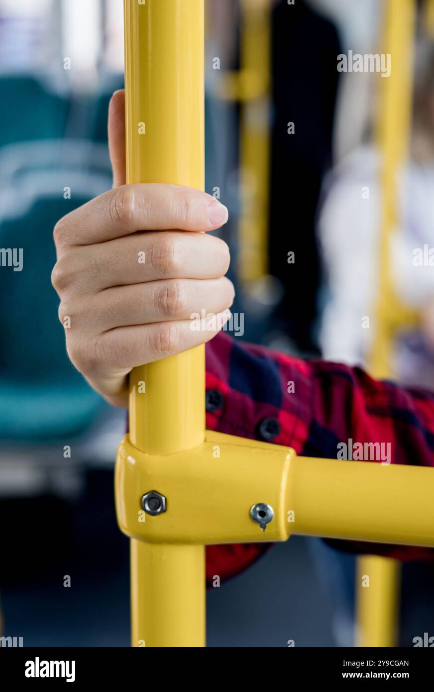Close-up of hand gripping handrail in public transportation. concept of ...