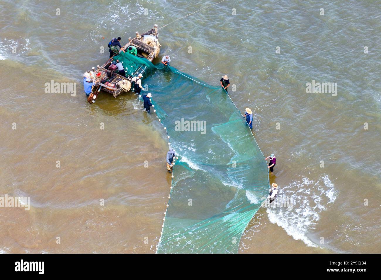 QINGDAO, CHINA - OCTOBER 9, 2024 - Fishermen cast long nets to catch ...
