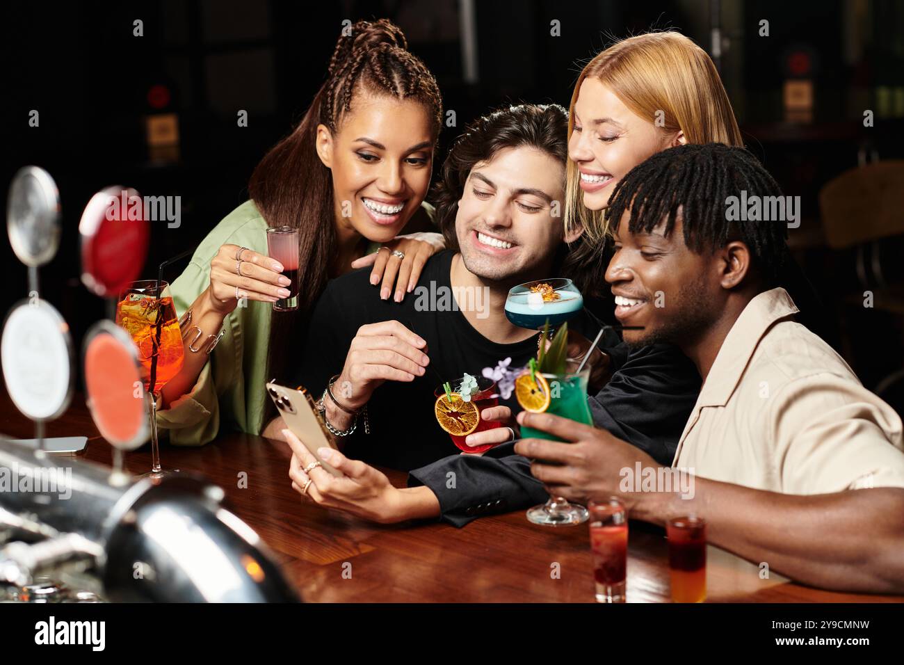 A diverse group of colleagues celebrates with colorful drinks, bonding ...