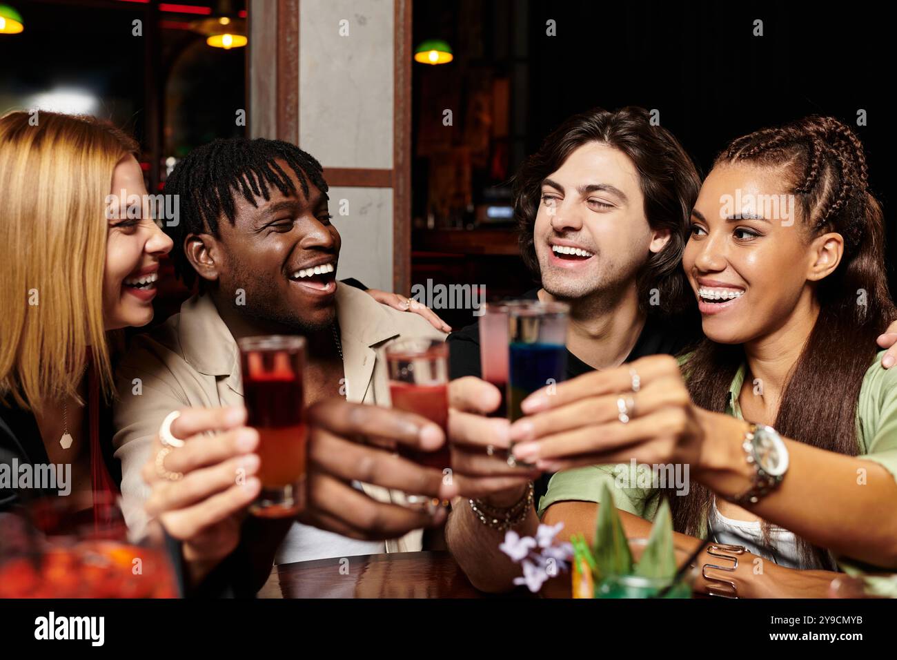 A lively celebration unfolds as young colleagues toast with vibrant ...