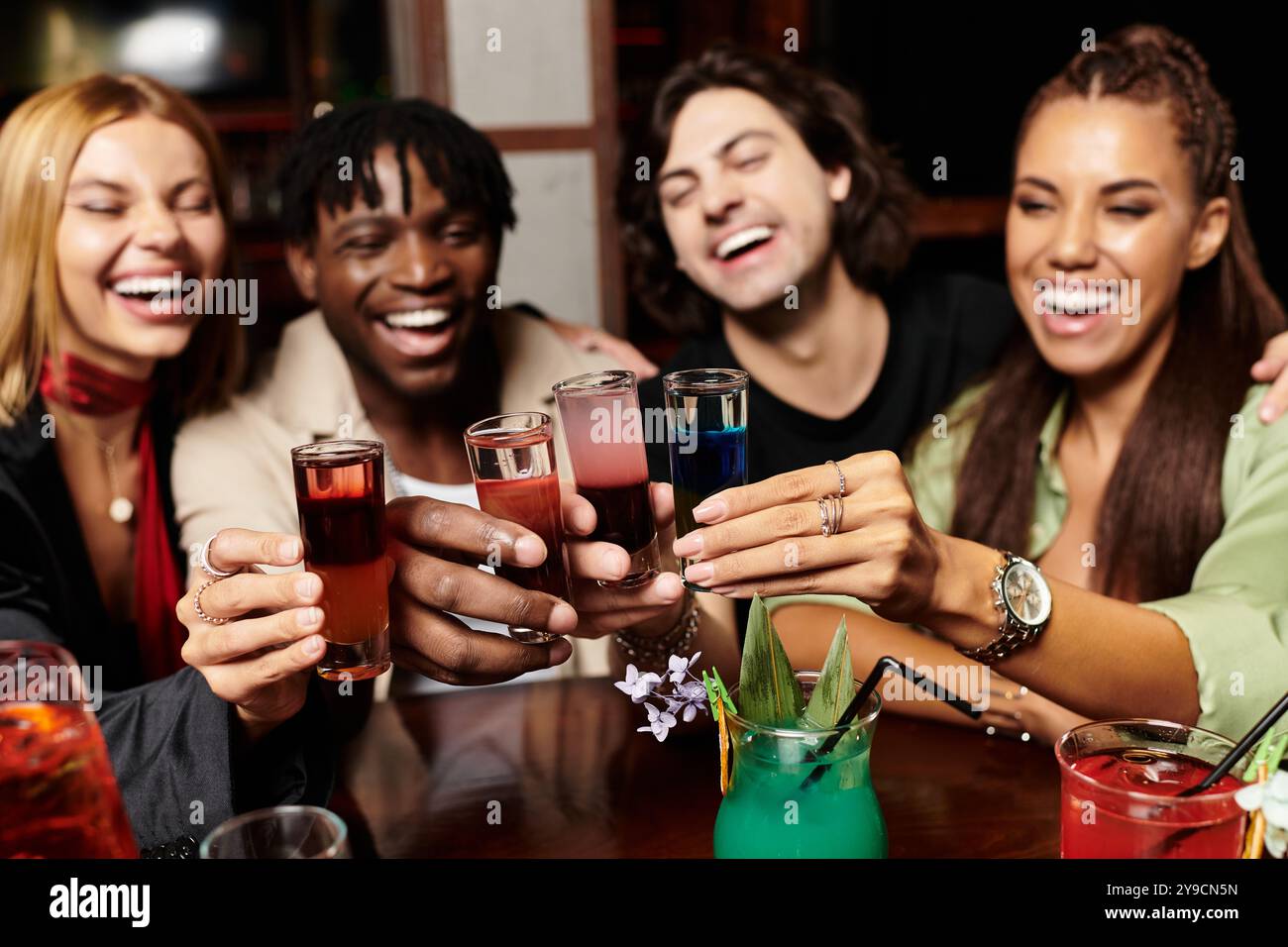 A vibrant gathering where colleagues laugh and toast with colorful ...