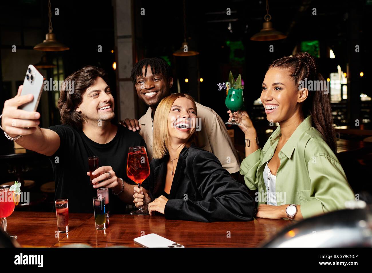 Colleagues celebrate together, sharing laughter and drinks at a vibrant ...