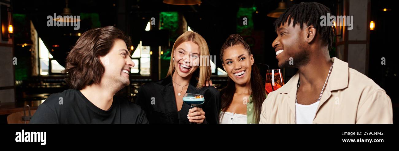 Diverse team members laugh and mingle together, enjoying drinks at a ...