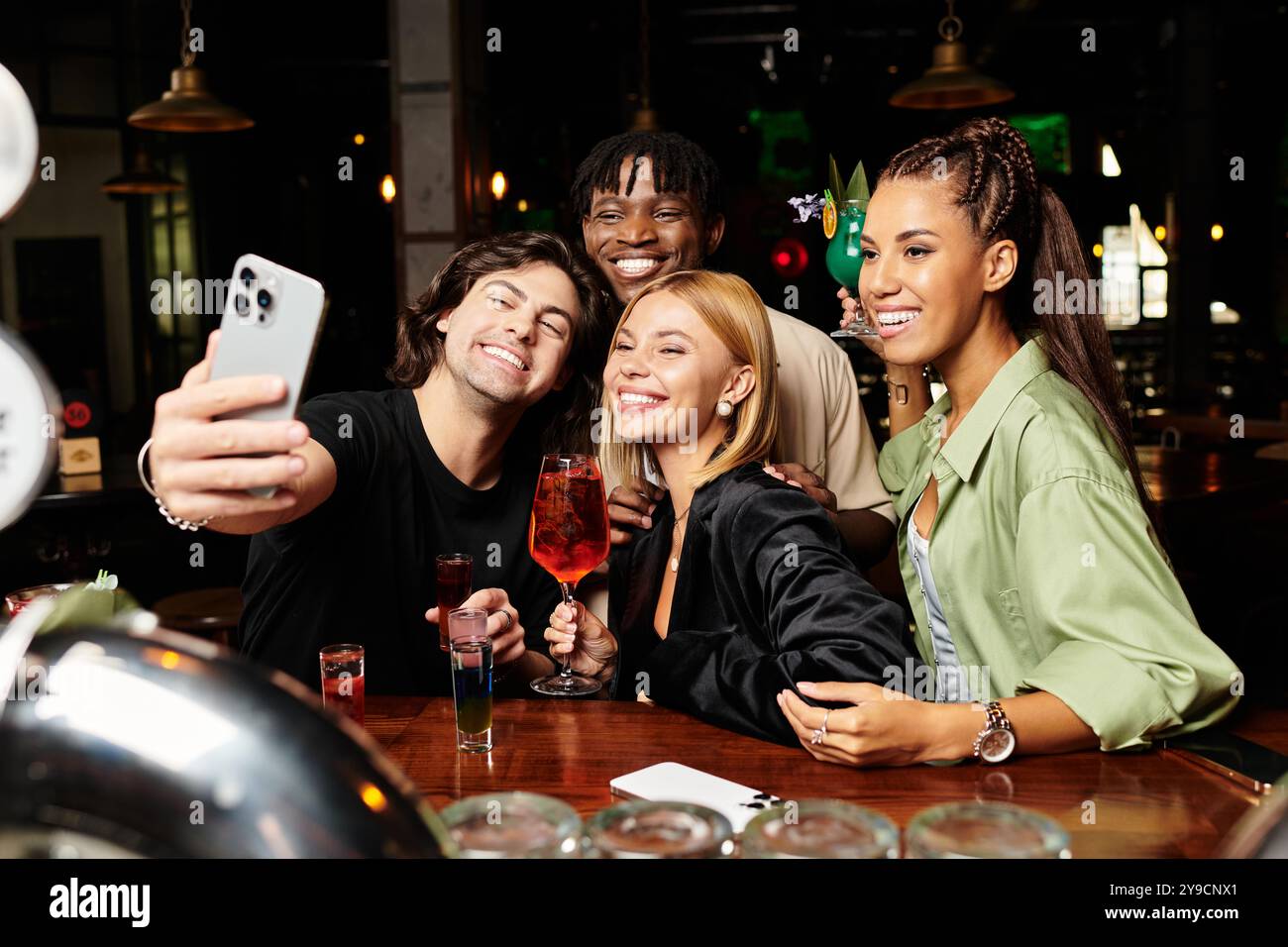 Young colleagues share smiles and capture memories at a lively ...