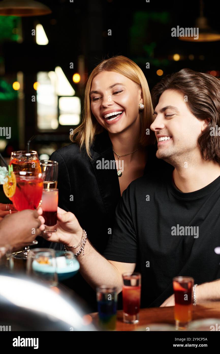 Young professionals laugh and toast at a corporate party, sharing ...