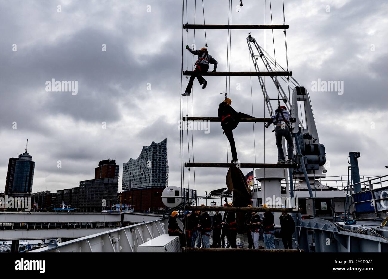10 October 2024, Hamburg: Dark rain clouds drift over the port of ...