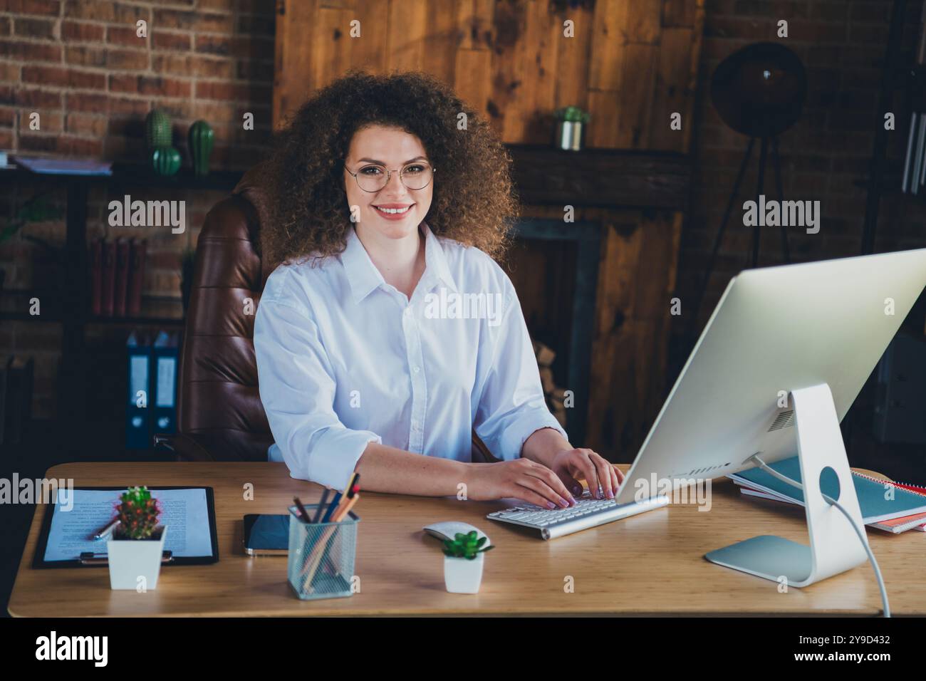 Photo of curly young woman typing keyboard work computer wear ...