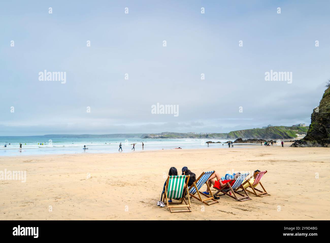 Visitors holidaymakers visitors tourists sitting in deckchairs on Towan ...