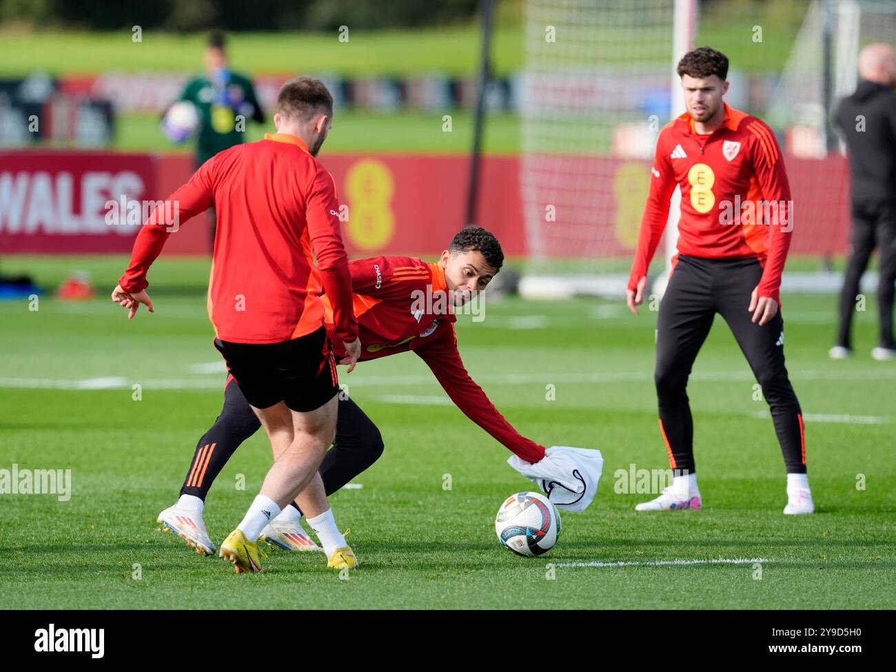 Wales' Brennan Johnson (centre) and Neco Williams (right) during a ...