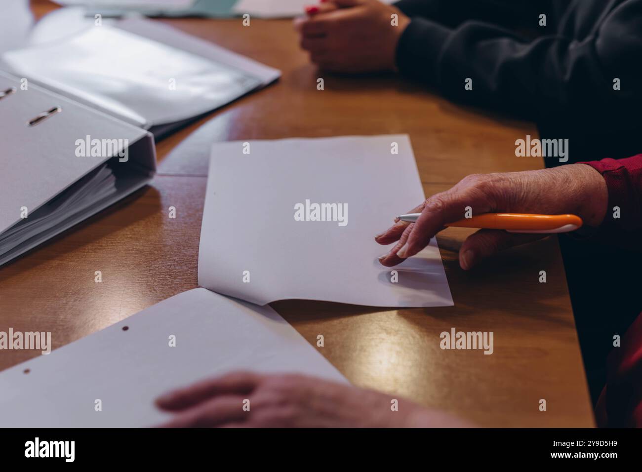 Old woman close up hand hold pen sign contract put signature.A woman ...