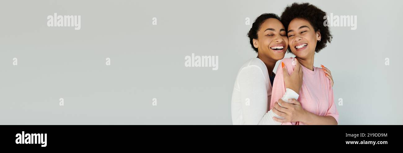 Two friends embrace warmly while laughing together in a bright ...