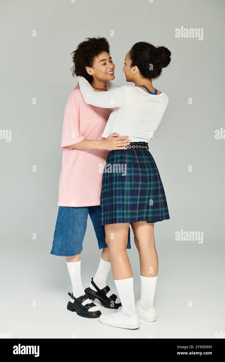 These two friends enjoy a lighthearted interaction, smiling as they ...