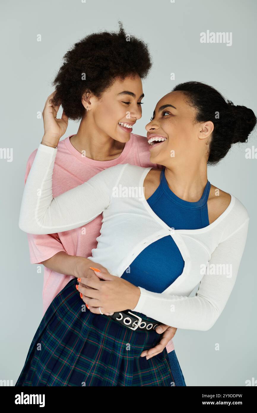 Two friends share a heartfelt moment, smiling and embracing each other ...