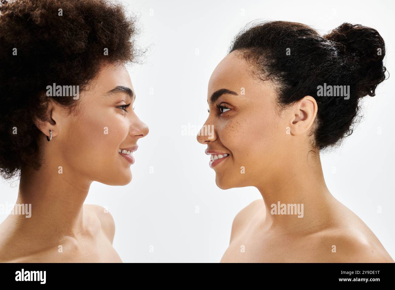 Two women face each other, highlighting their unique features and ...
