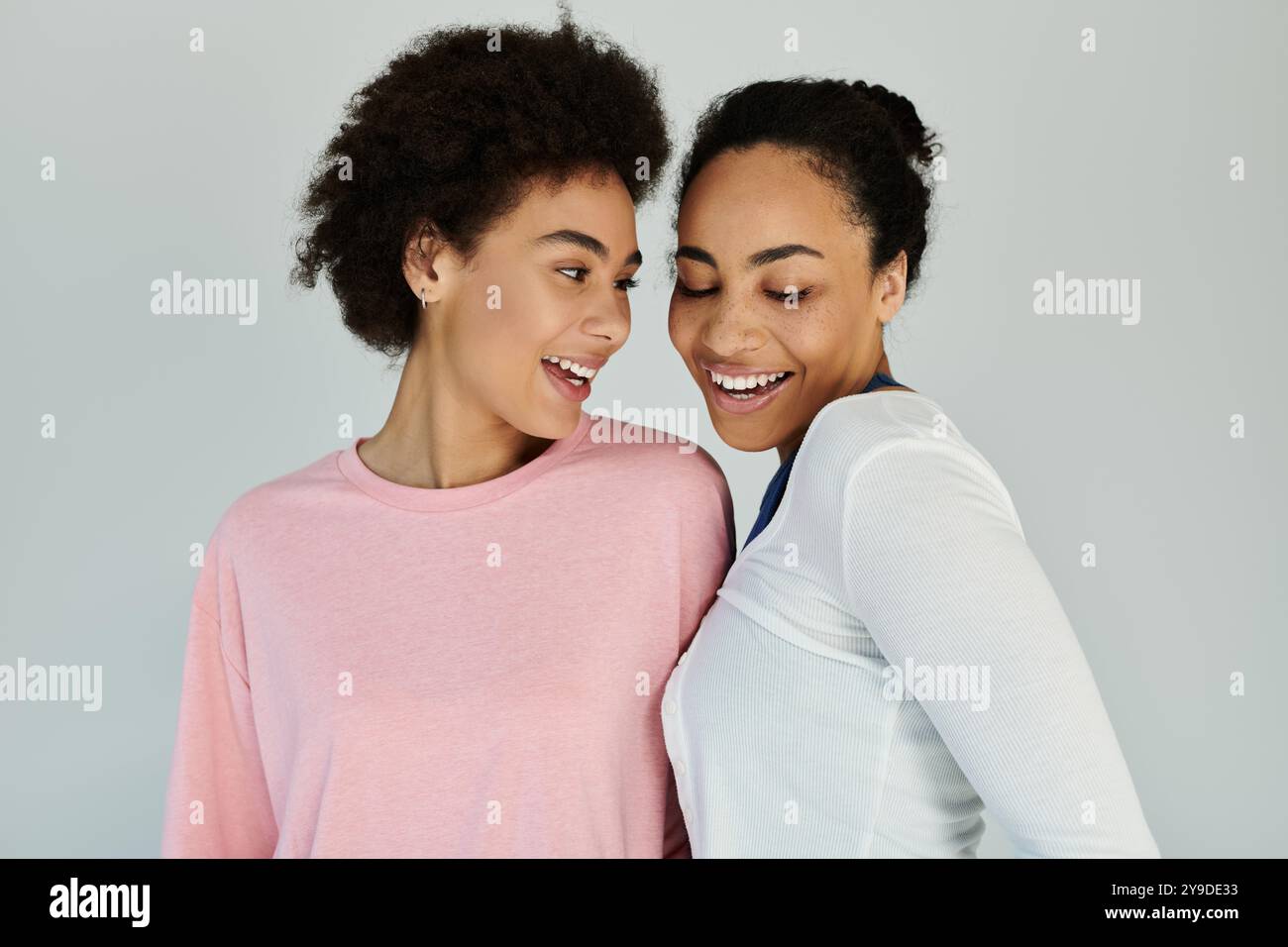 Two women express joy and connection, showcasing their happiness in a ...