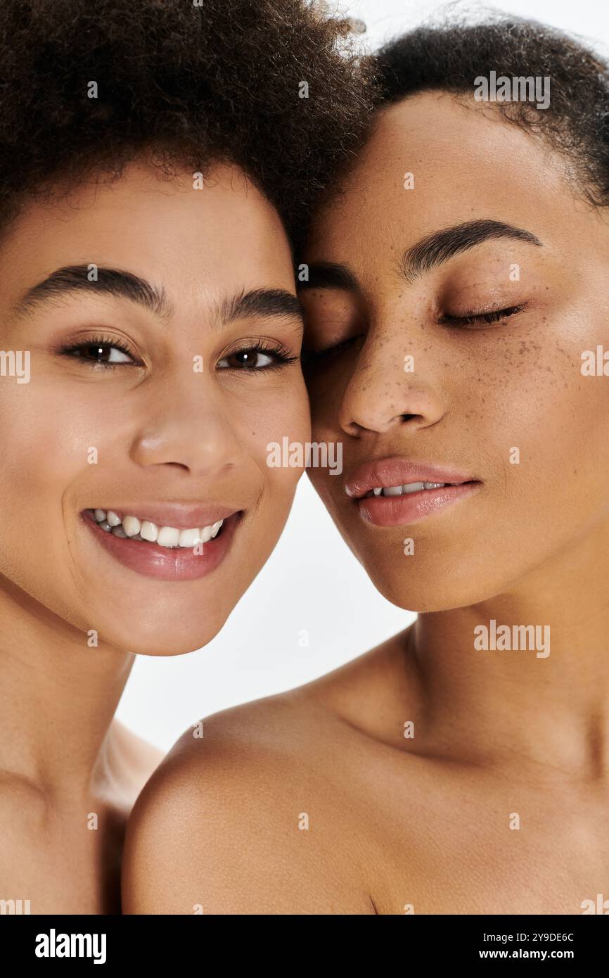 Two women share a moment of joy and closeness, showcasing natural ...