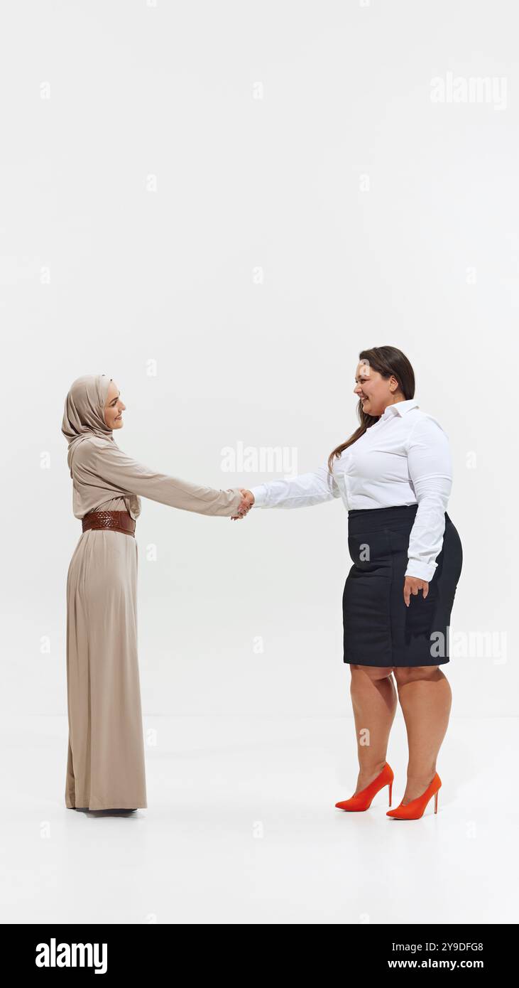 Two businesswomen of different body types and cultural backgrounds ...