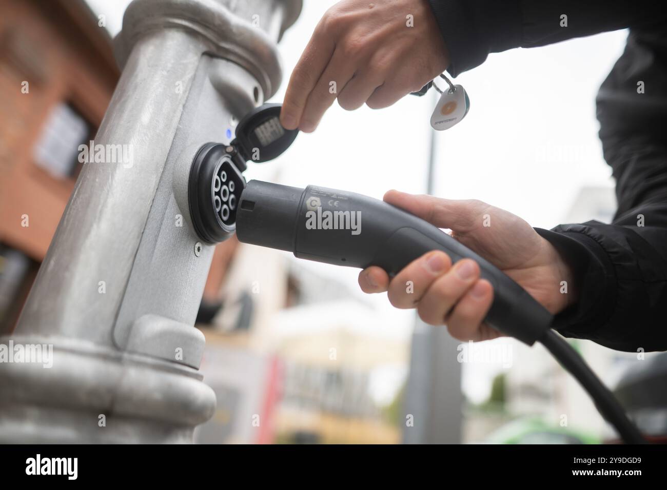 Berlin, Germany. 25th Sep, 2024. A man inserts a plug for charging an ...
