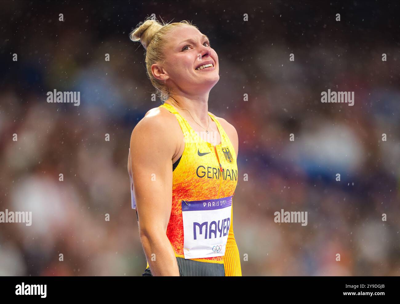 Lisa Mayer celebrating with her country's flag in the 4X100 meters ...