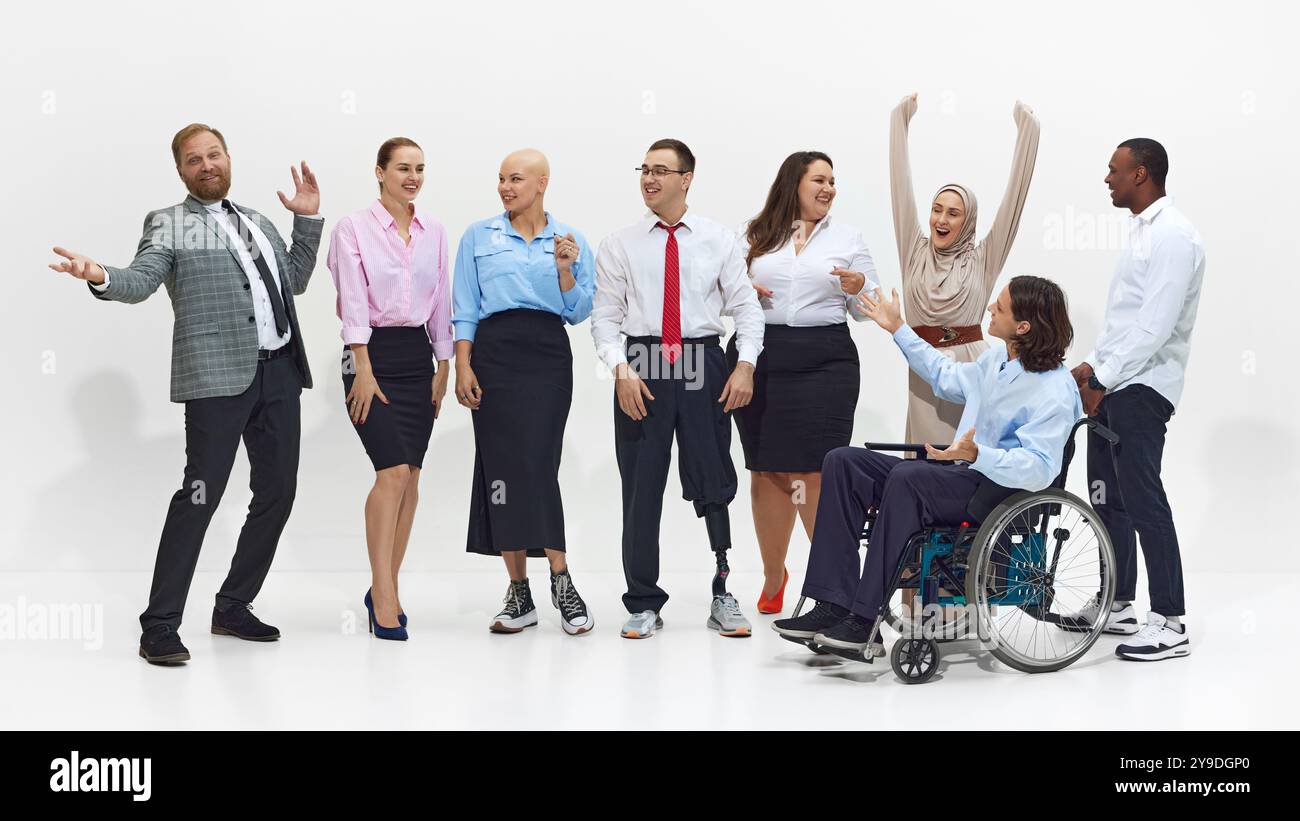 Diverse group of colleagues engage in lively conversation, smiling and ...