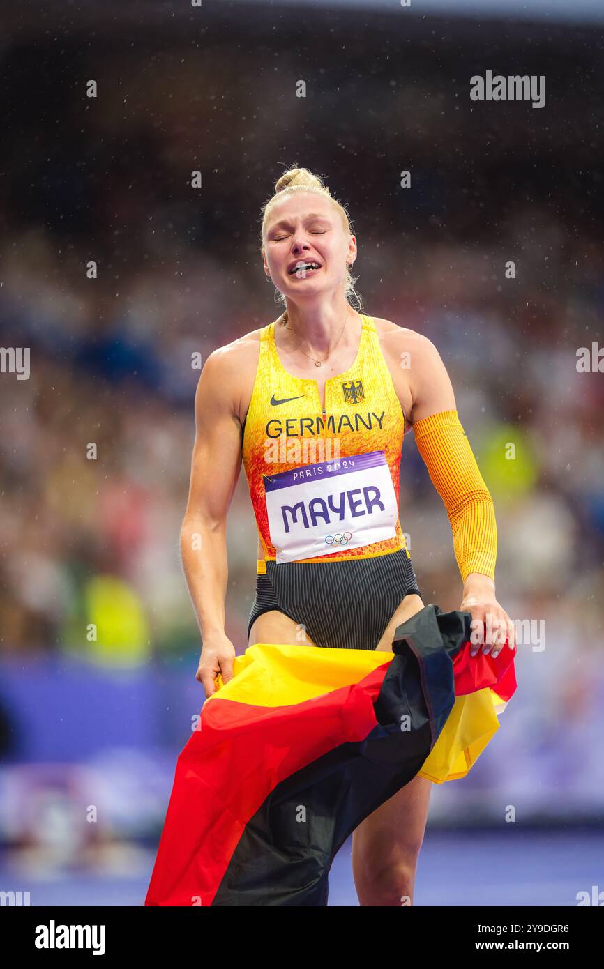 Lisa Mayer celebrating with her country's flag in the 4X100 meters ...