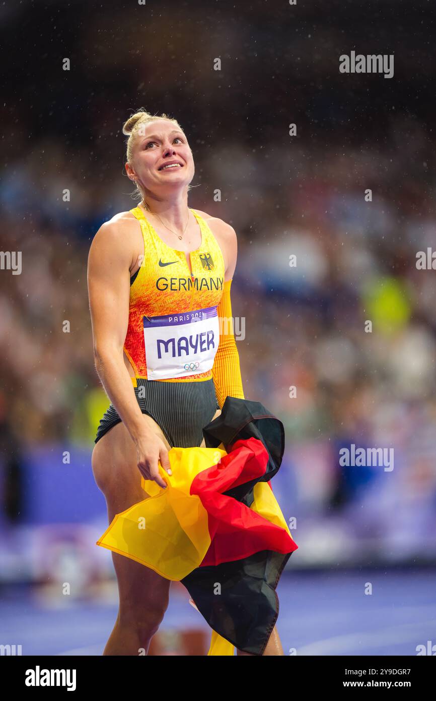 Lisa Mayer celebrating with her country's flag in the 4X100 meters ...