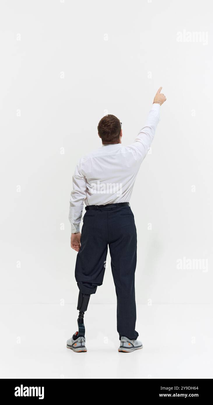 Man with prosthetic leg pointing upwards, symbolizing ambition and ...