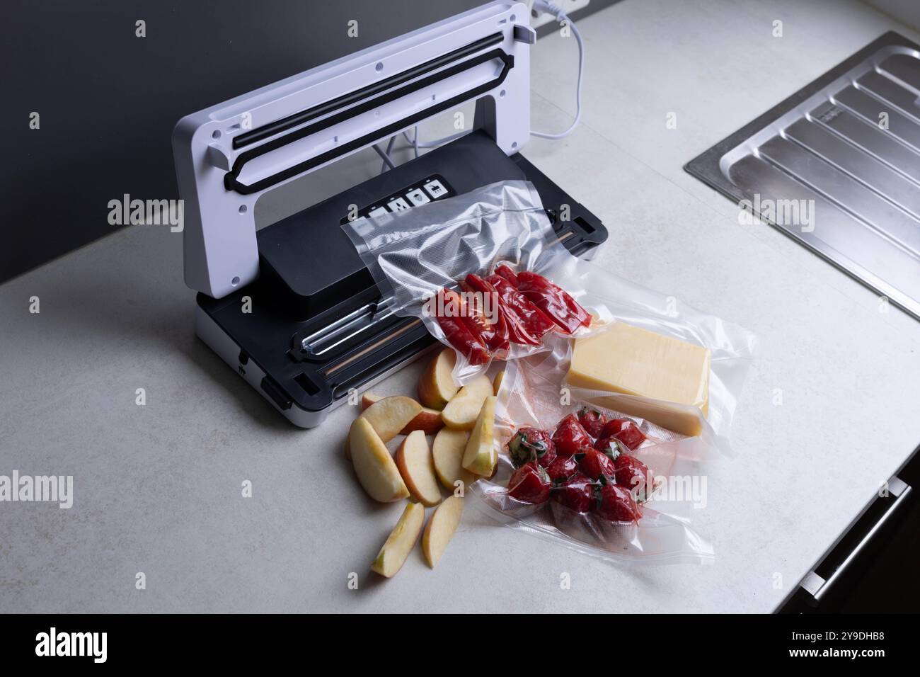 Vacuum packaging machine packs strawberries hi-res stock photography ...