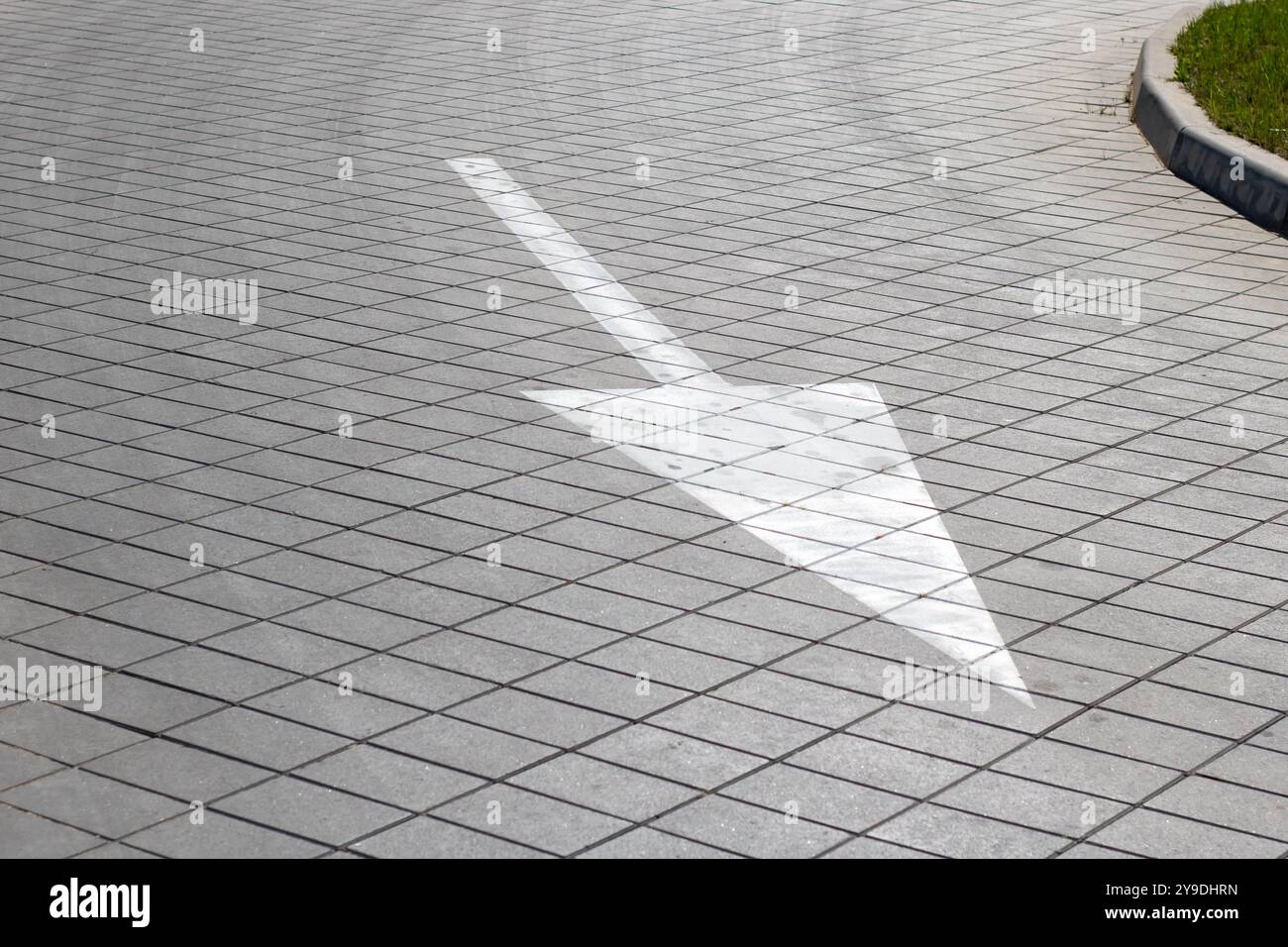 A large white arrow, designed to point towards the right direction, is ...