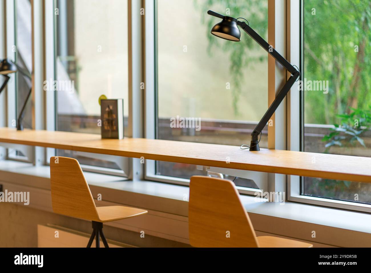 Place to read a book near the window in the city library Stock Photo ...
