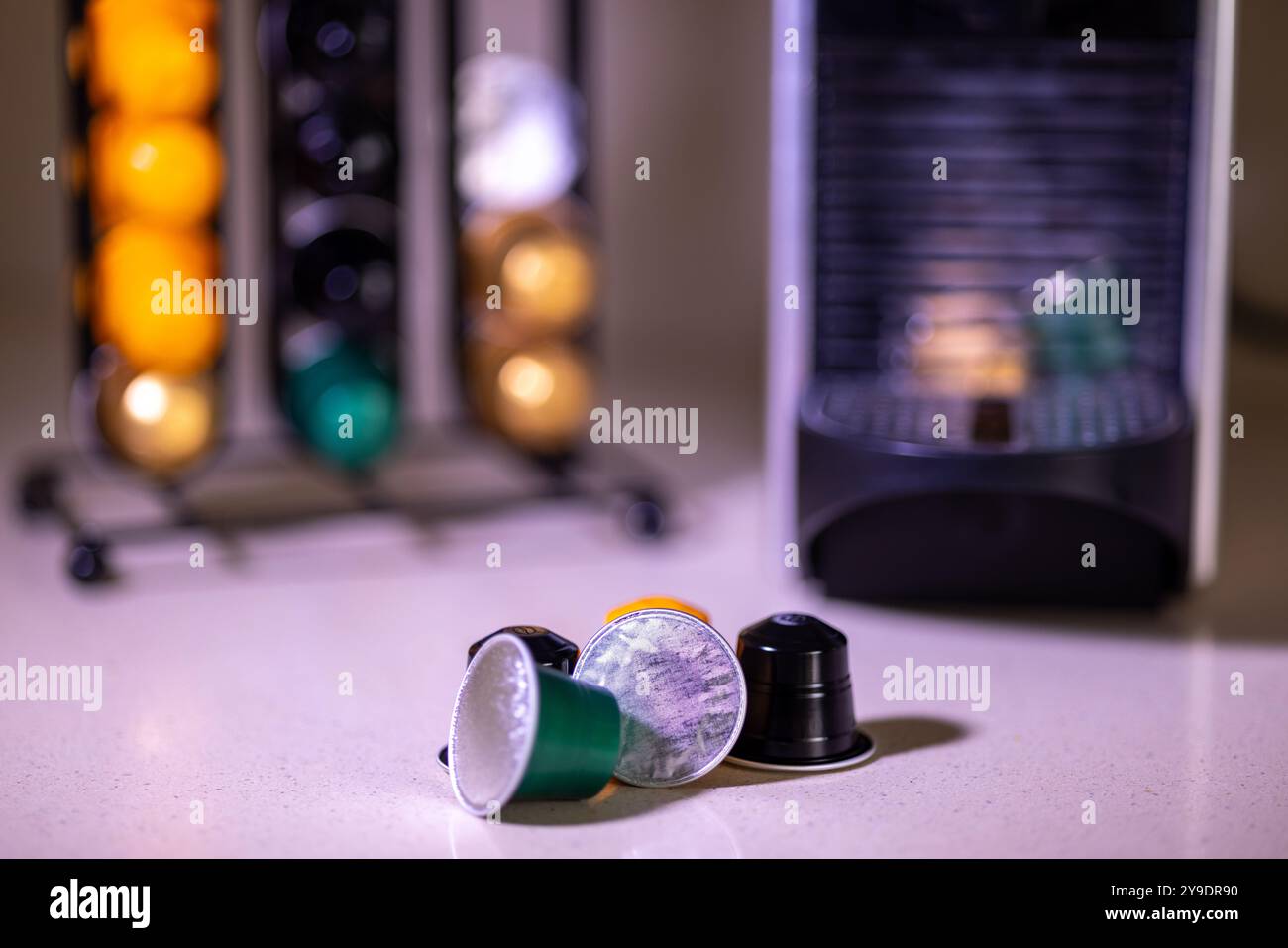 Assorted coffee capsules are placed in front of a capsule storage unit ...