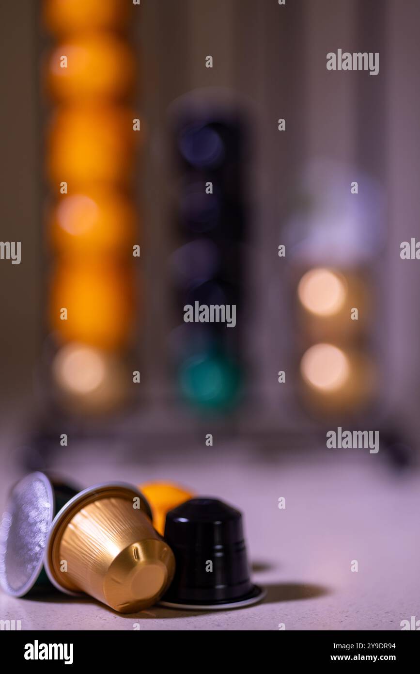 Coffee capsules are lined up neatly on a surface, with a stylish coffee ...