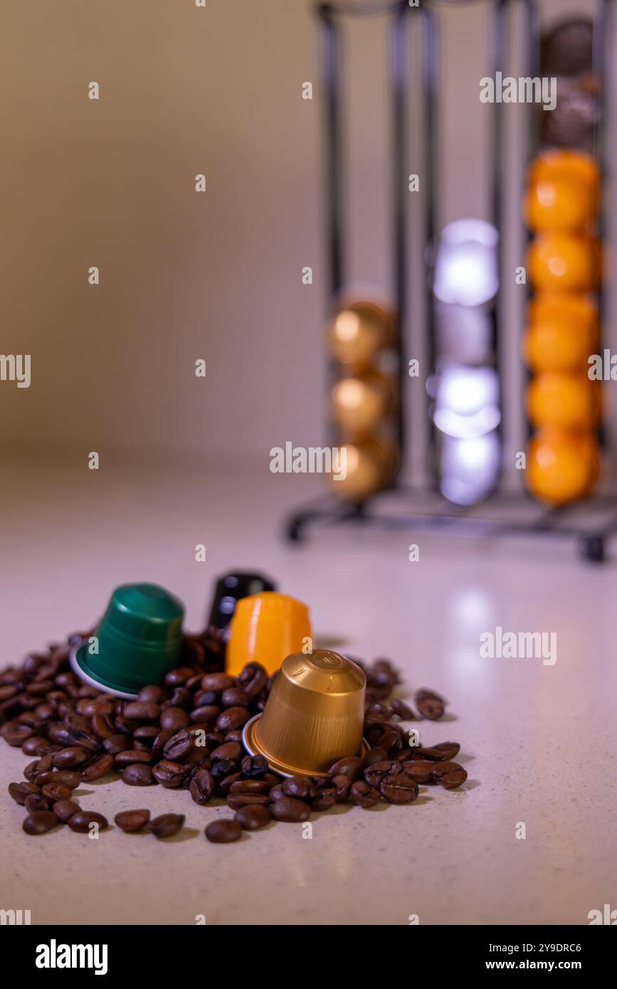 A detailed shot of colorful coffee capsules on top of coffee beans. A ...