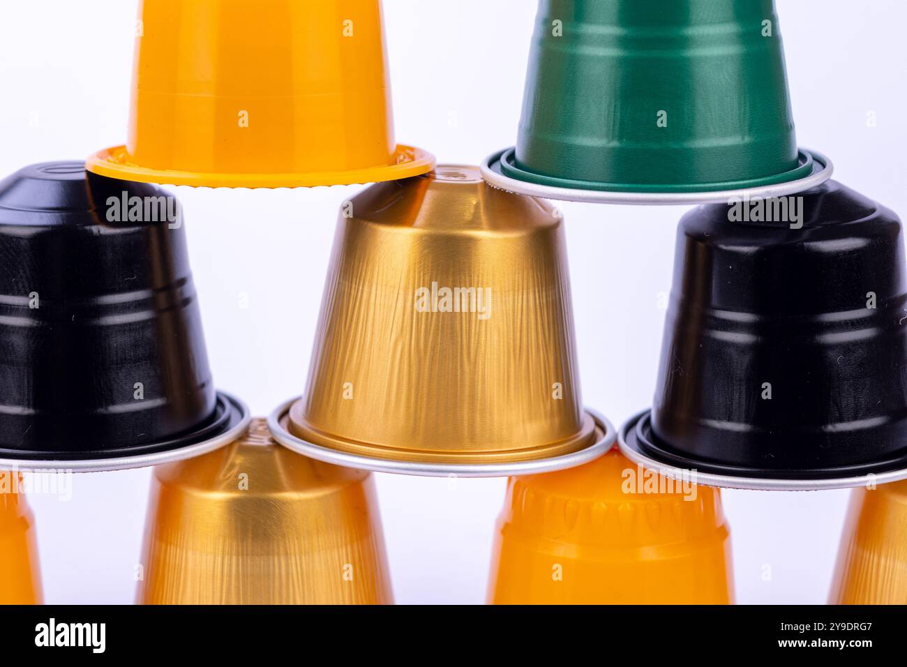 A vibrant pyramid of coffee capsules in various colors stands out ...