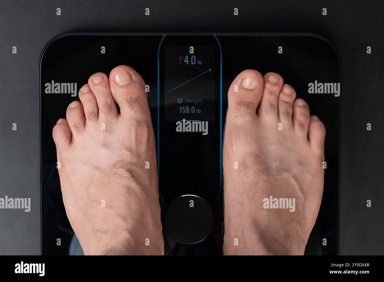 Increase body weight theme. Standing on weight close up view Stock ...