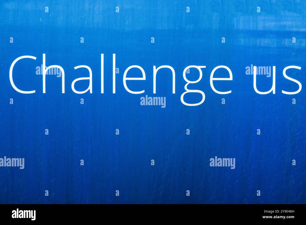 The bright blue backdrop features a bold invitation "Challenge us" to ...