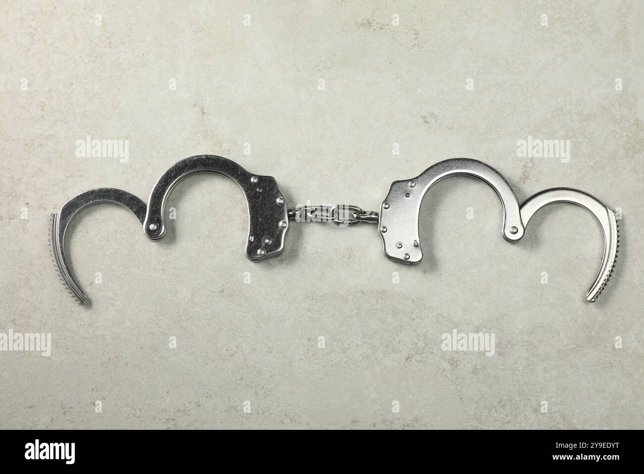Classic chain handcuffs on grey table, top view Stock Photo - Alamy