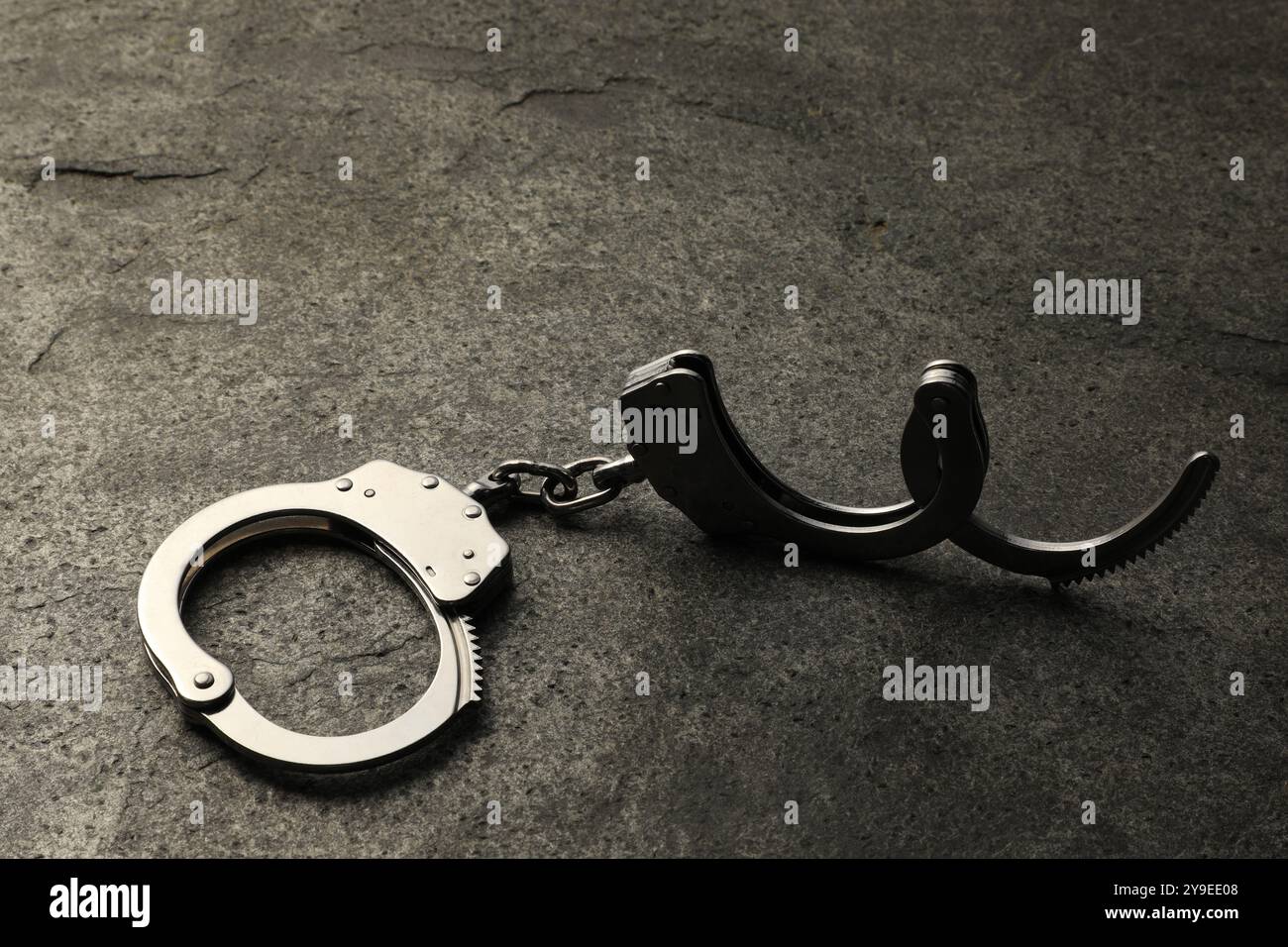 Classic chain handcuffs on grey table, closeup Stock Photo - Alamy