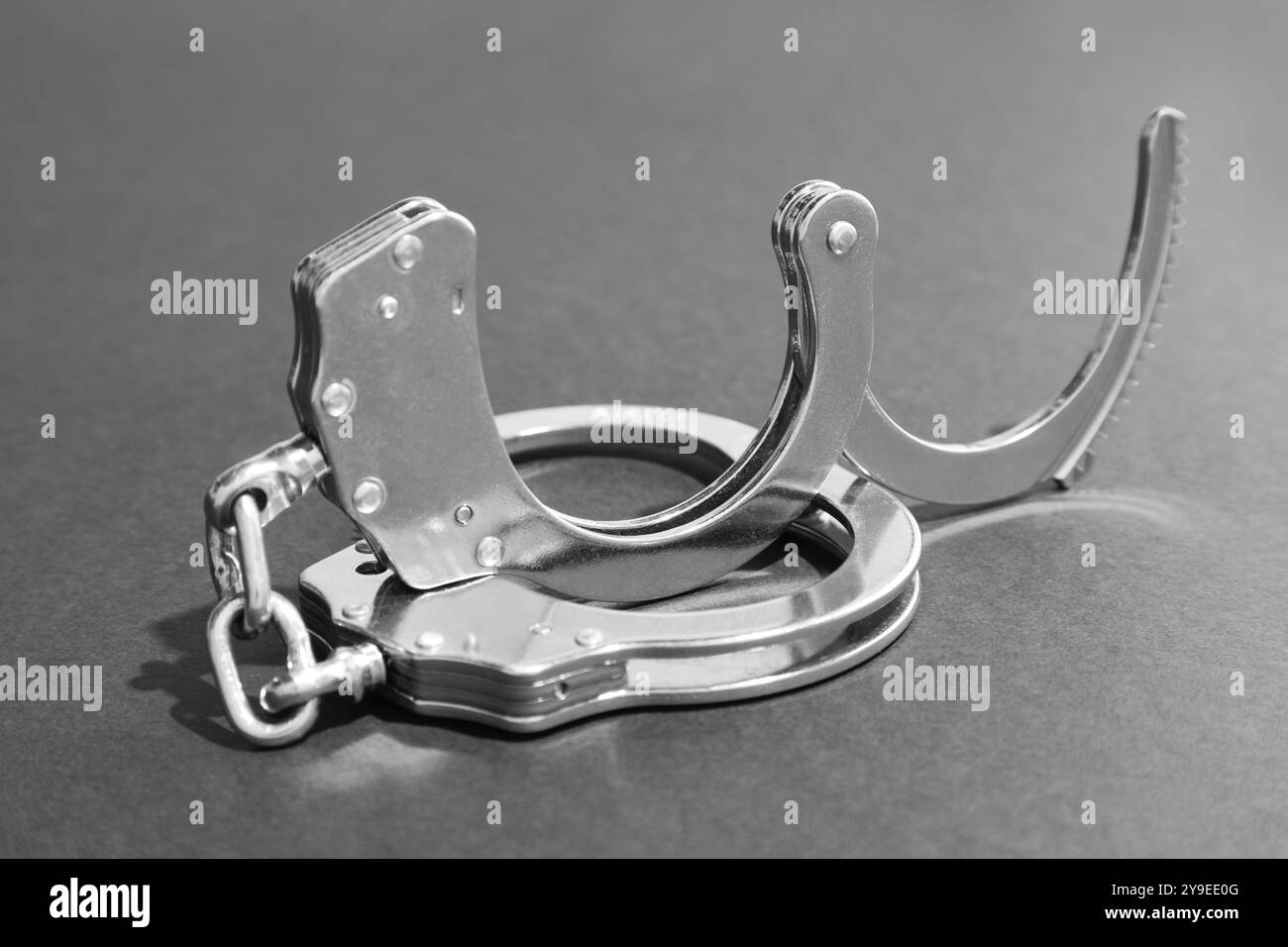 Classic chain handcuffs on grey background, closeup Stock Photo - Alamy