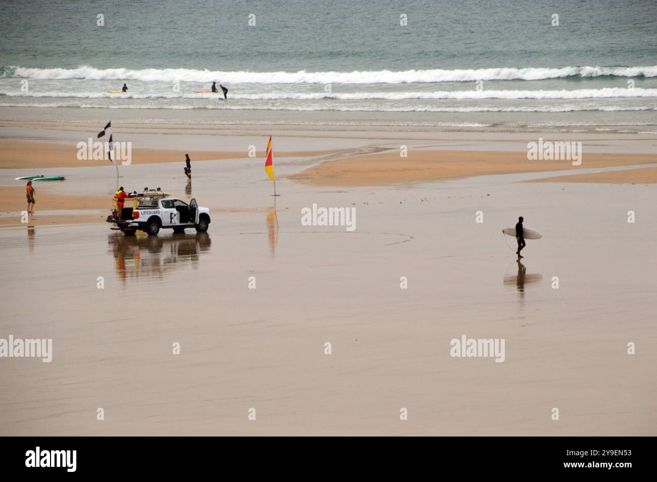Surfer Walking by RNLI Lifeguards and Ford Ranger Vehicle on the Beach ...