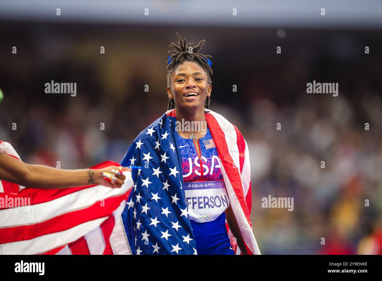 Sha'Carri Richardson celebrating with her country's flag in the 4X100 ...
