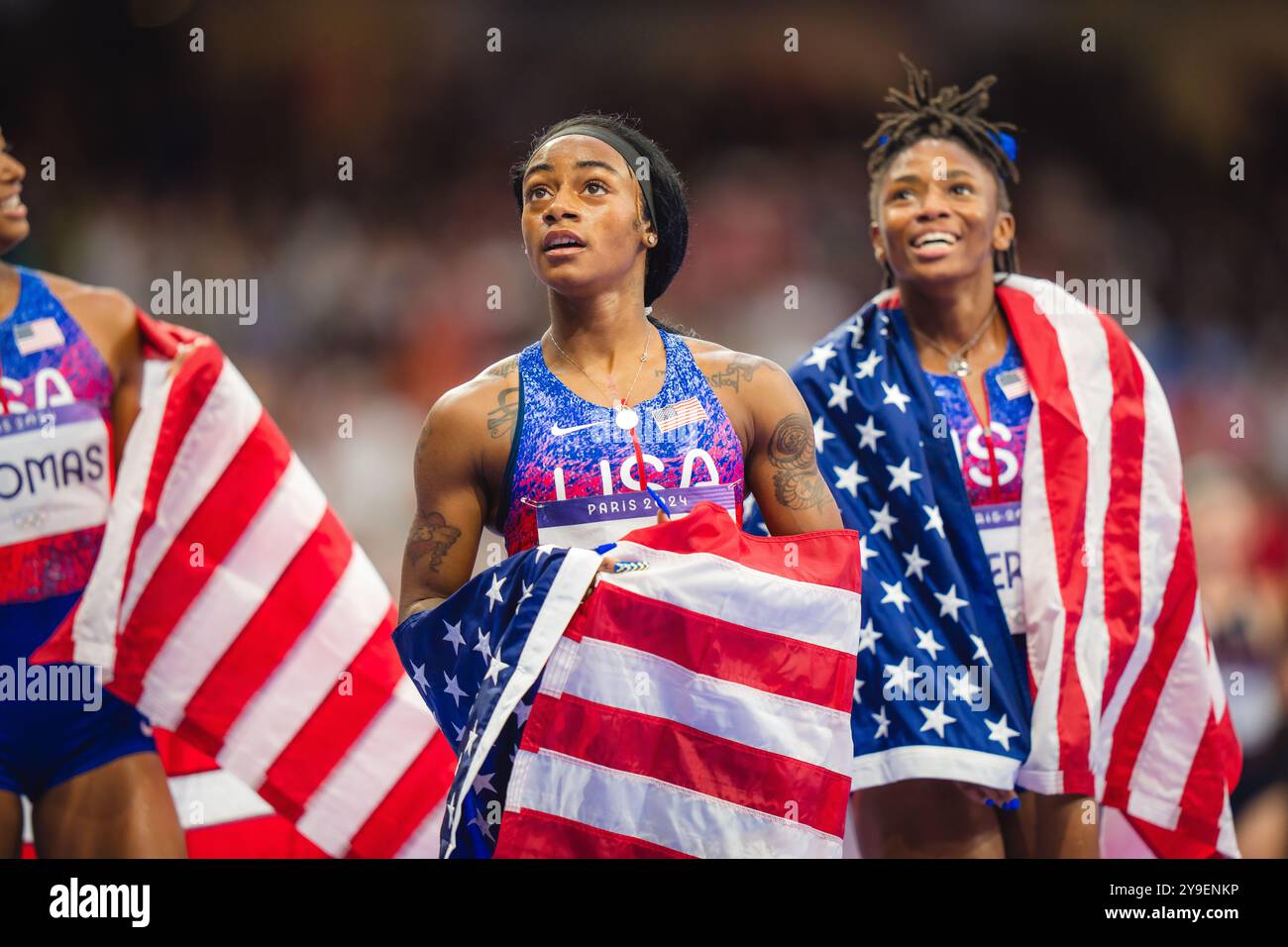 Sha'Carri Richardson celebrating with her country's flag in the 4X100 ...