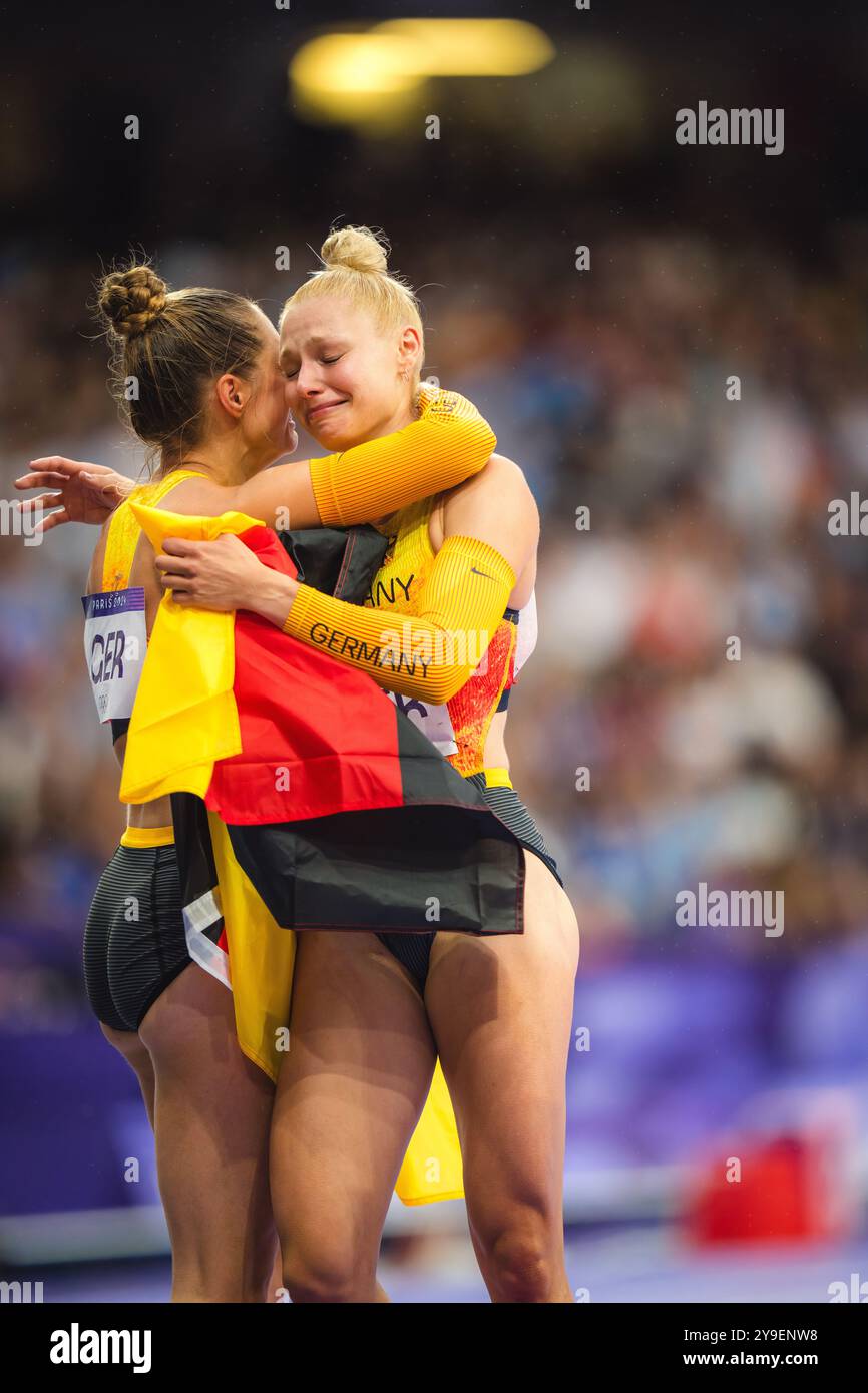 Lisa Mayer celebrating with her country's flag in the 4X100 meters ...